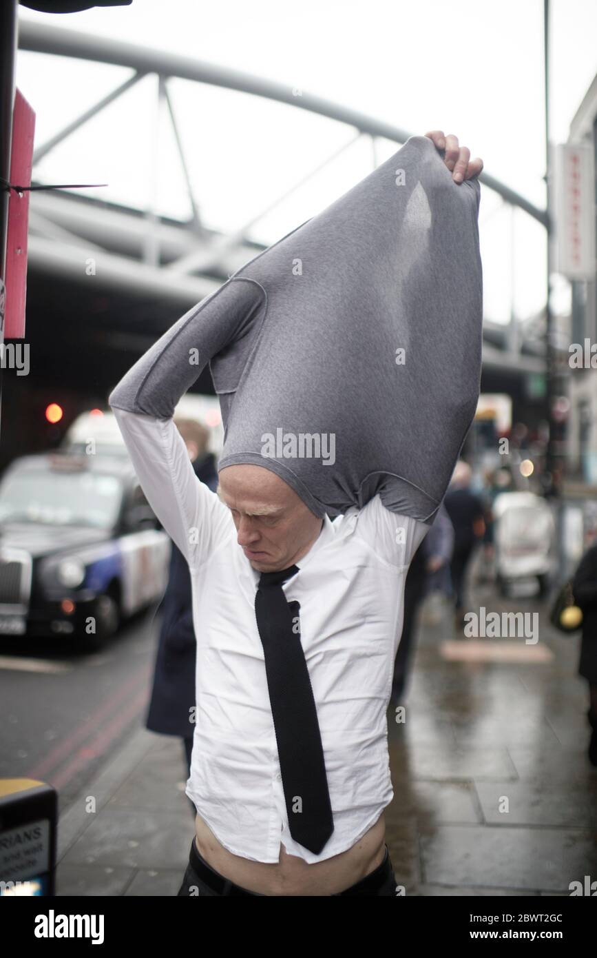 Man taking off coat hi-res stock photography and images - Alamy