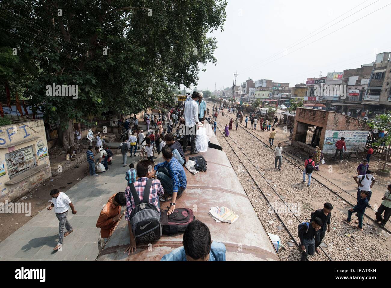 Men on top of overcrowded train passing through countryside in Madhya ...