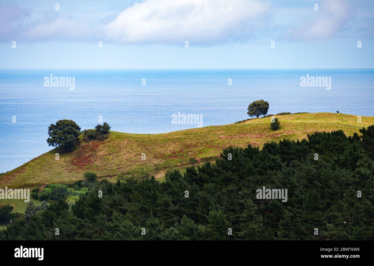 Landscape with hill, forest, sea and blue sky with clouds. Irun, Basque ...
