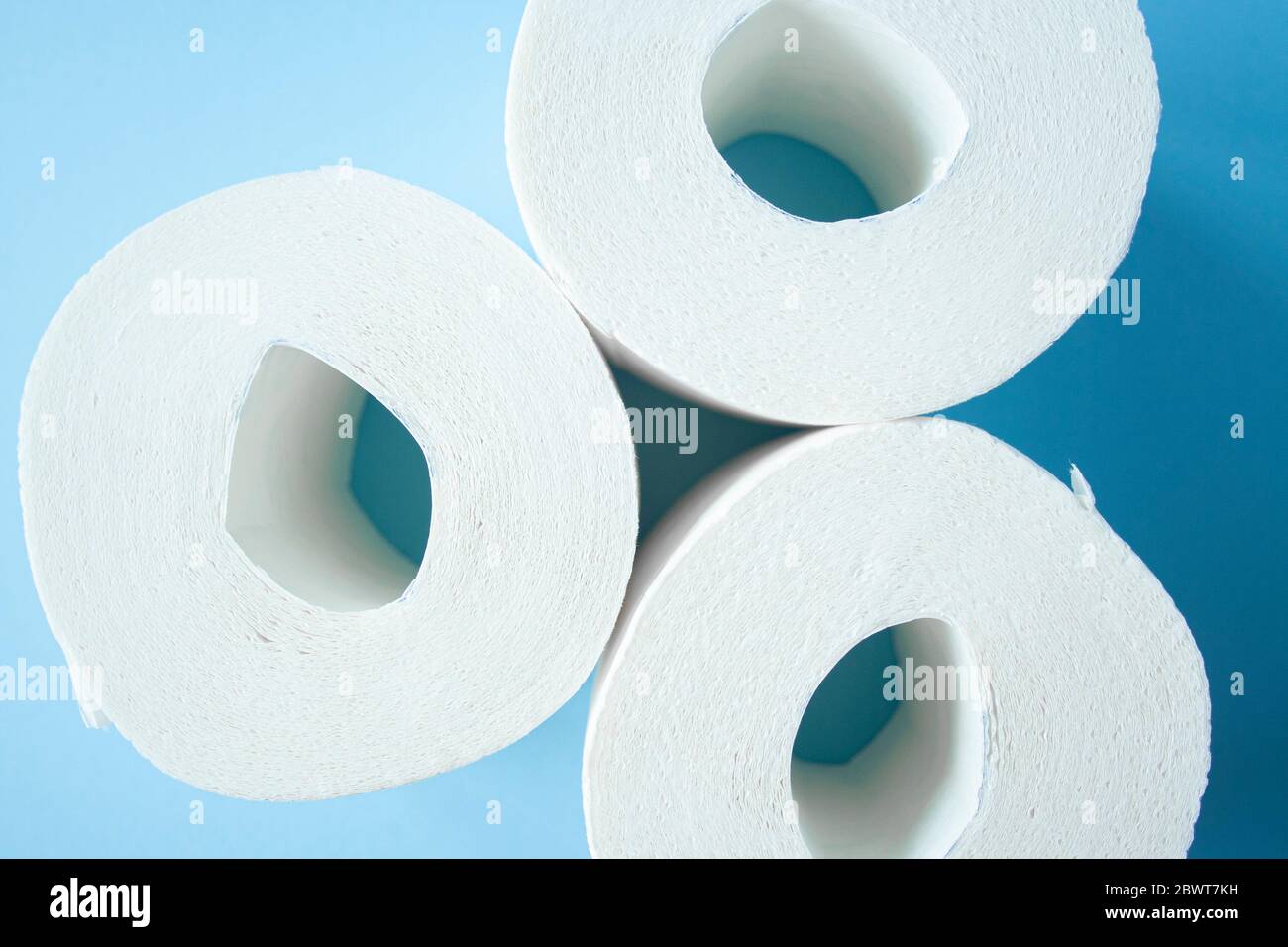 Toilet paper roll on a blue background top view Stock Photo - Alamy