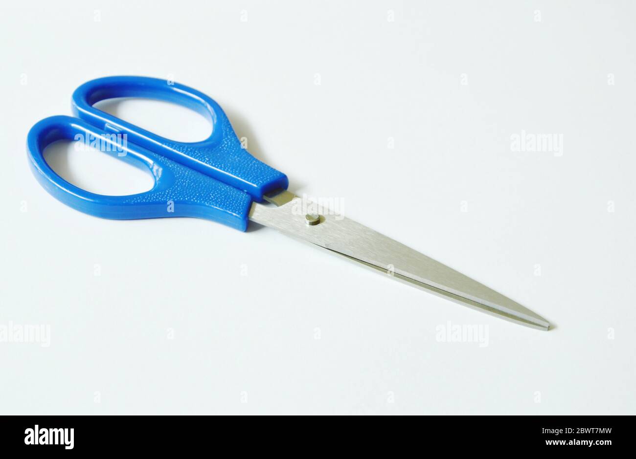 scissor with blue handle on white background Stock Photo - Alamy