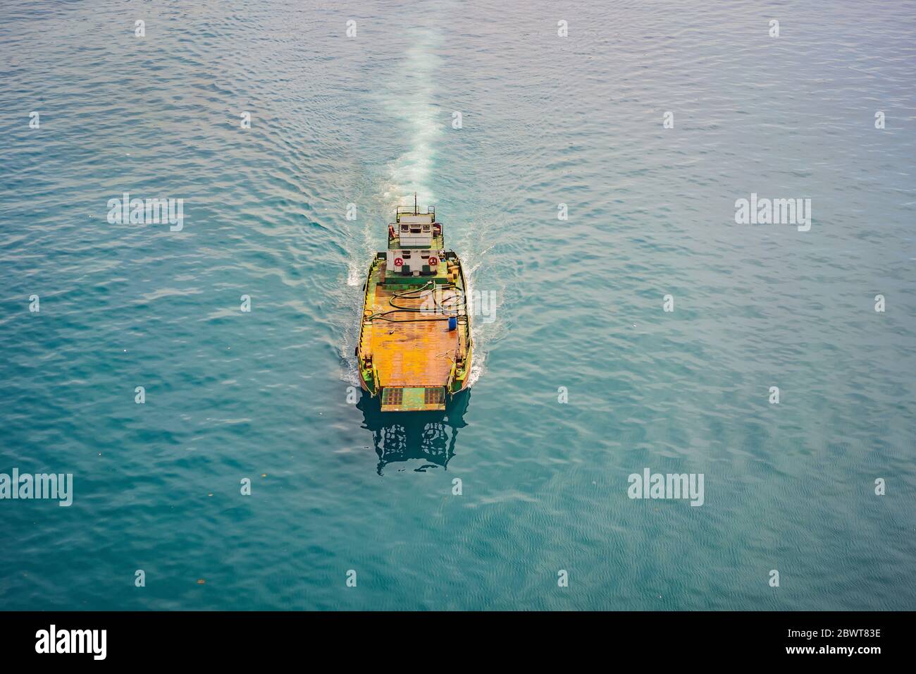 Aerial drone photo of small ferry cruising open ocean sea Stock Photo ...