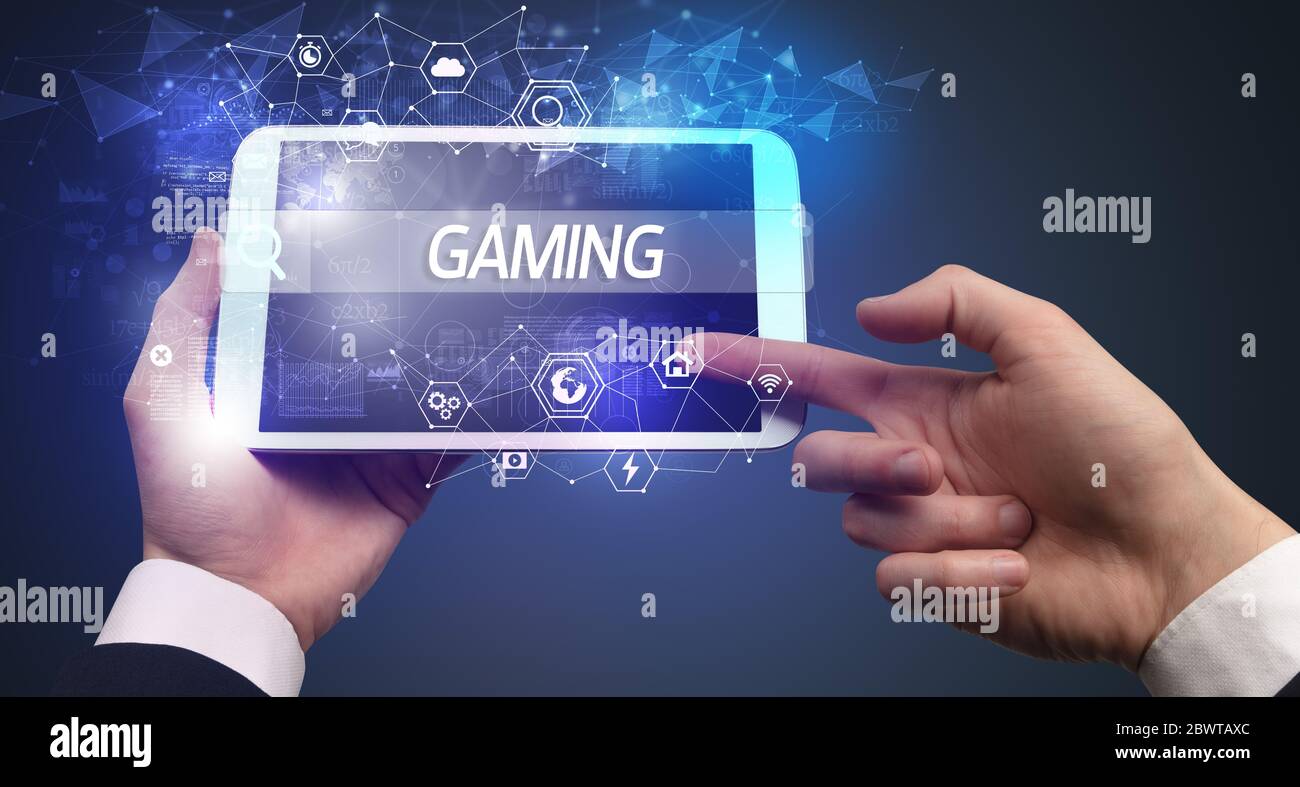 Close-up of a tablet searching GAMING inscription, hi-tech computing ...