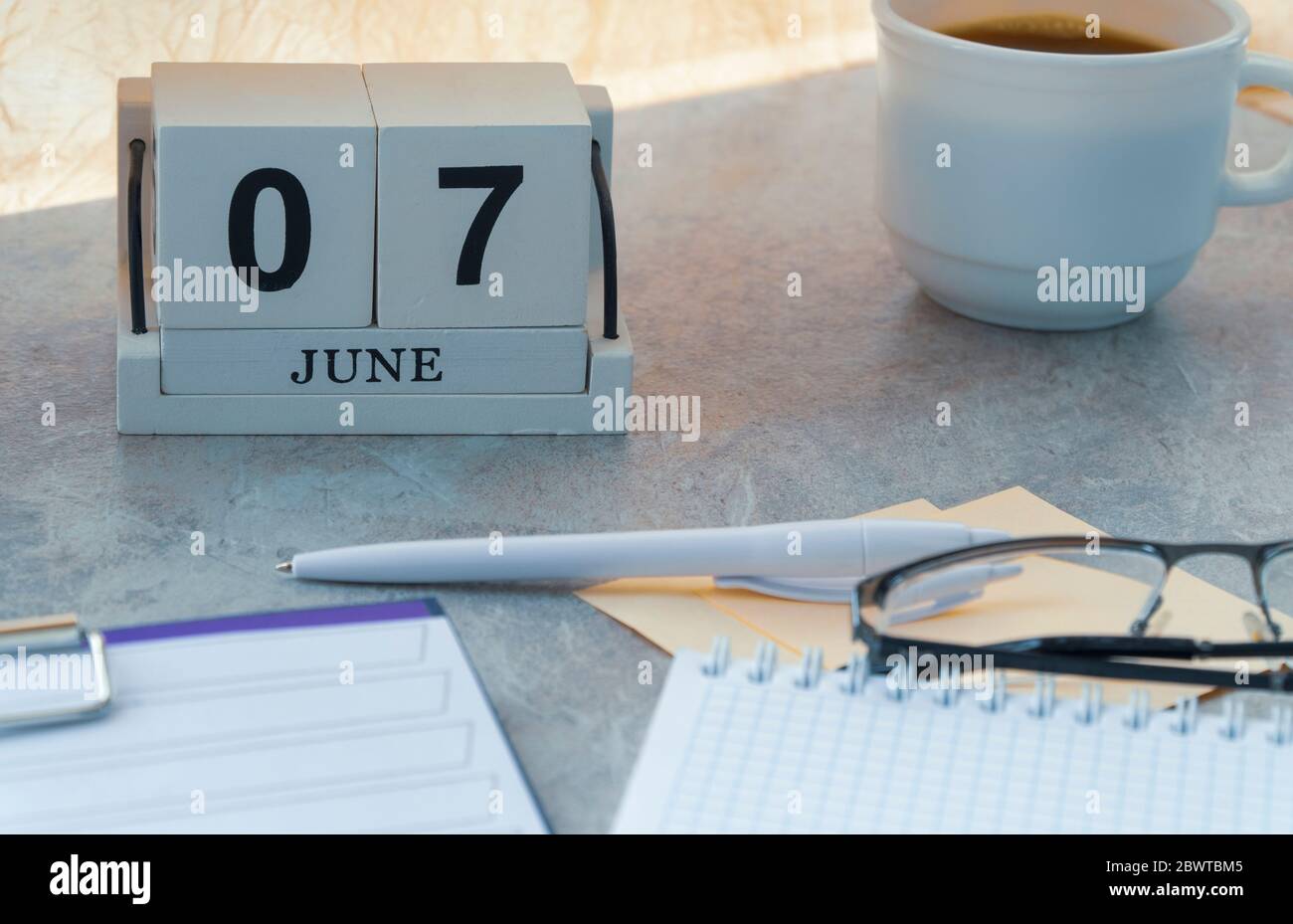 June 07, date on the calendar. Handmade wood cube with date month and ...