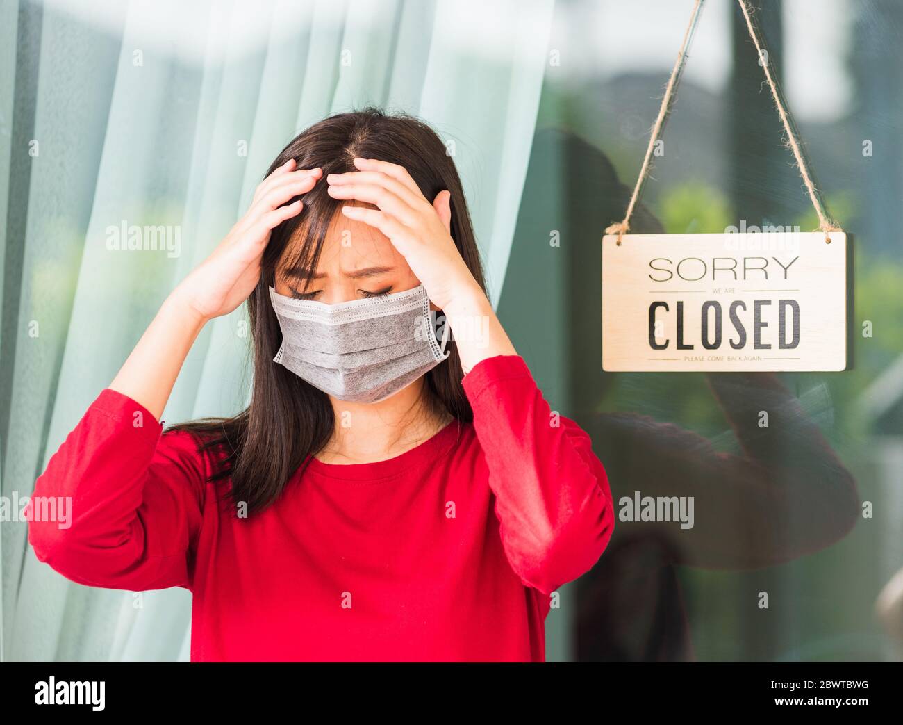 Asian young woman wear face mask protect she sad notice sign wood board ...