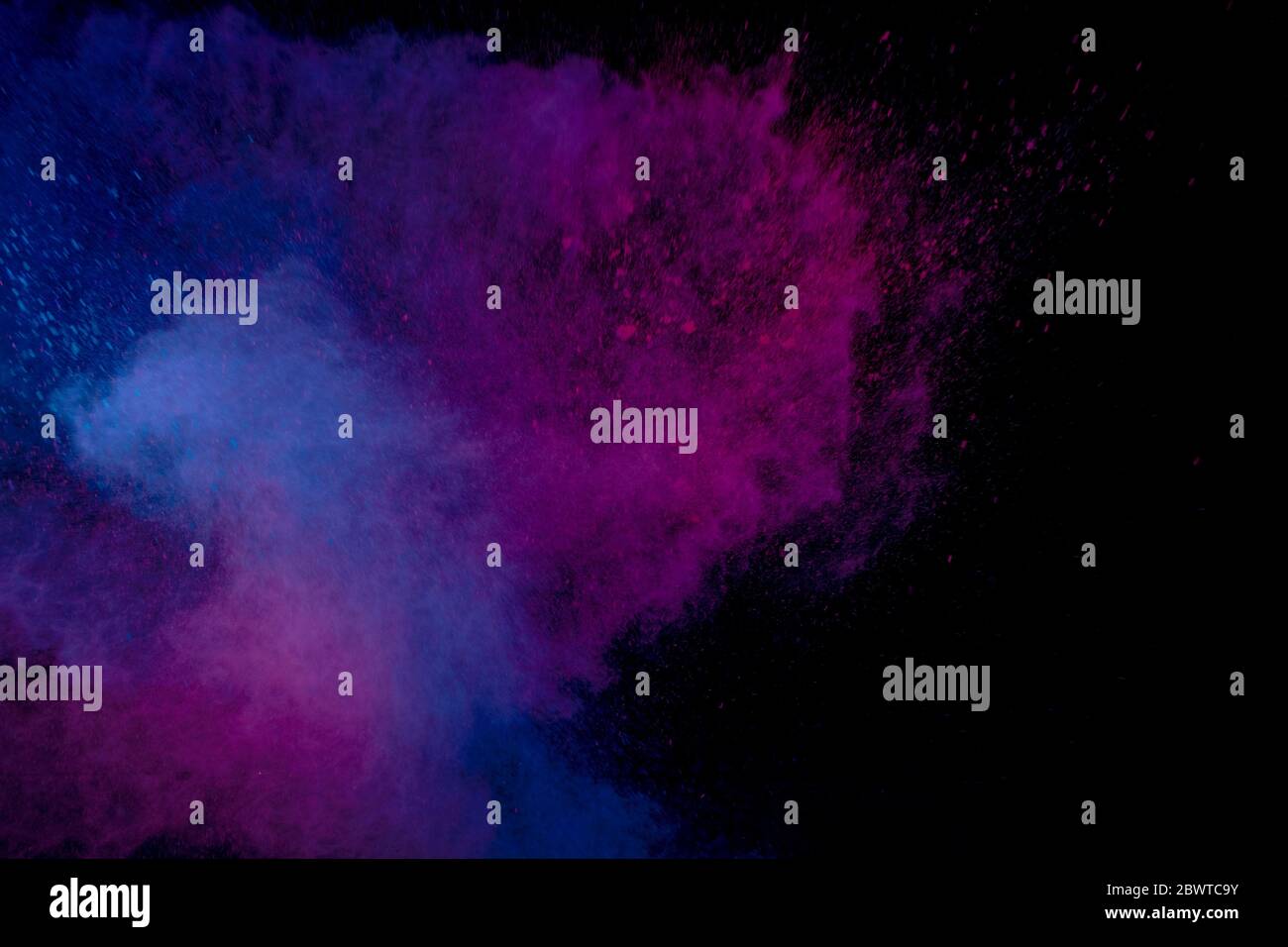 Abstract colored dust explosion on a black background.abstract powder ...