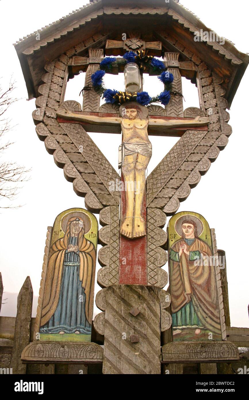 Roadside crucifix in Romania's countryside. Traditionally sculpted ...
