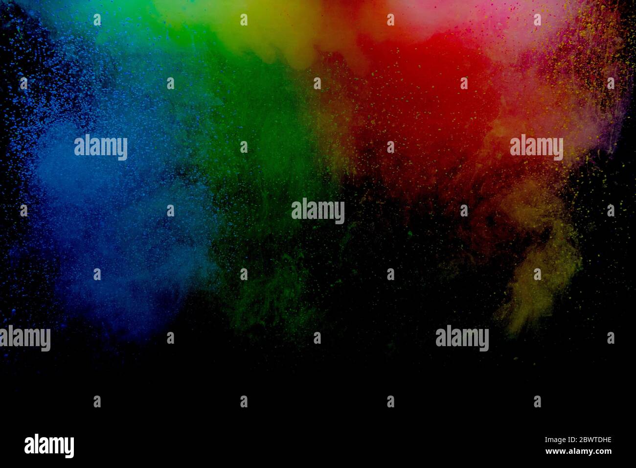 Abstract colored dust explosion on a black background.abstract powder ...