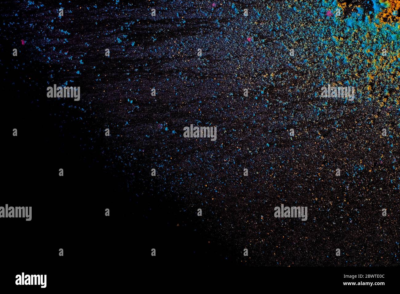 Abstract colored dust explosion on a black background.abstract powder ...
