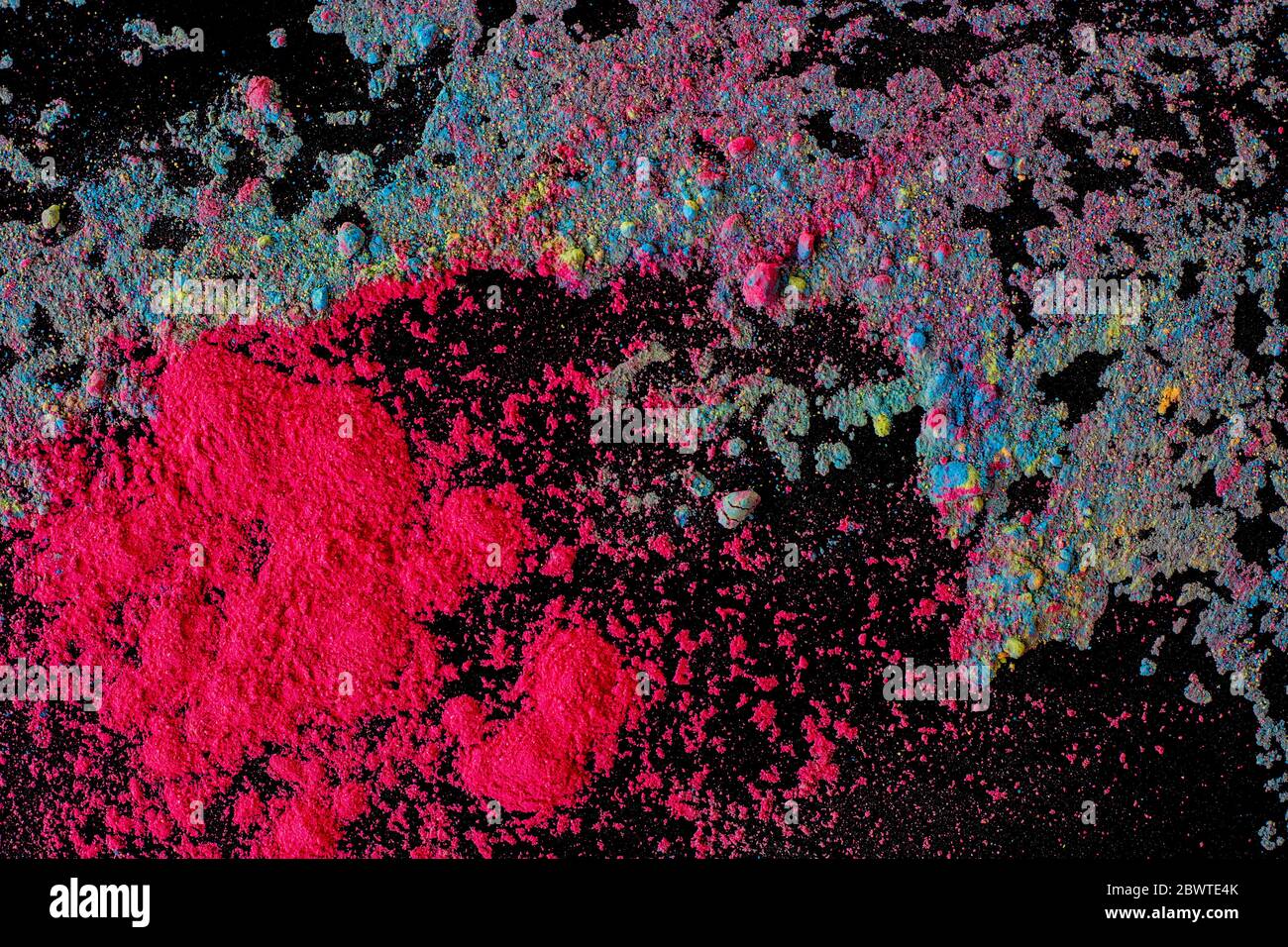 Abstract colored dust explosion on a black background.abstract powder ...