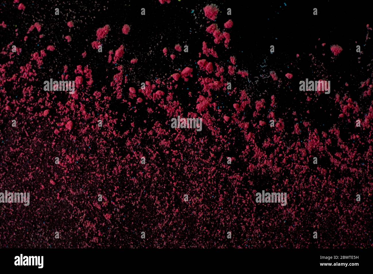 Abstract colored dust explosion on a black background.abstract powder ...