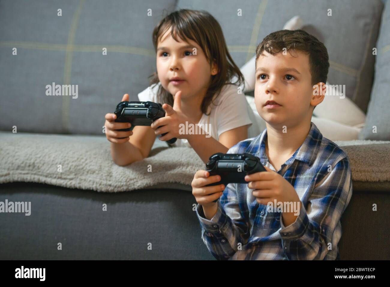 kids playing console games durring covid 19 outbreak Stock Photo - Alamy