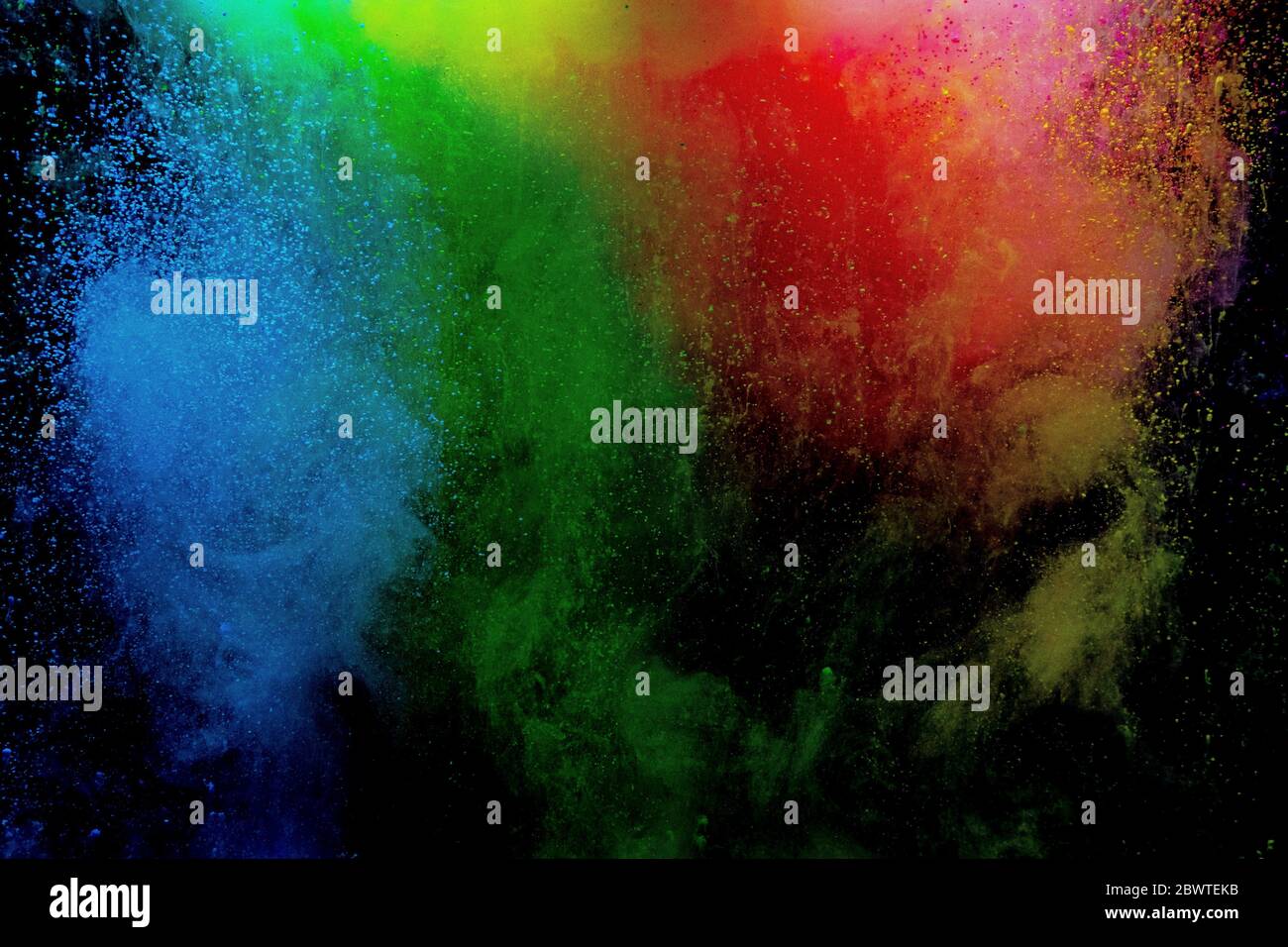 Abstract colored dust explosion on a black background.abstract powder ...