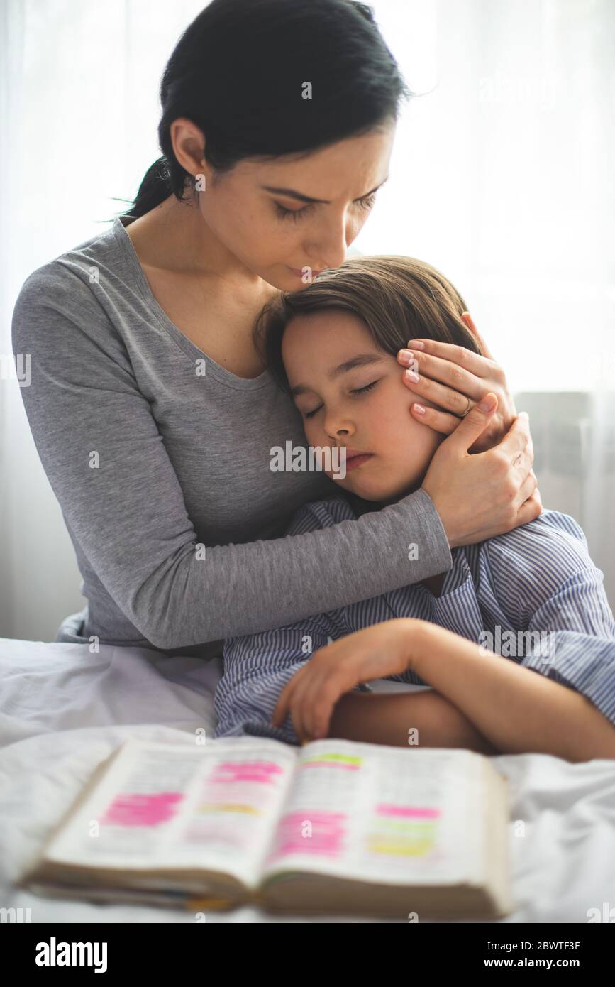 Family praying bed hi-res stock photography and images - Alamy
