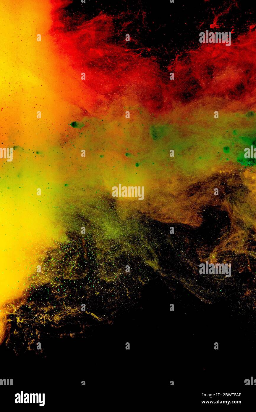 Abstract colored dust explosion on a black background.abstract powder ...