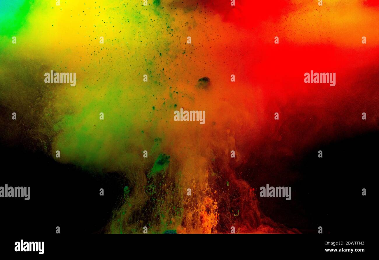 Abstract colored dust explosion on a black background.abstract powder ...
