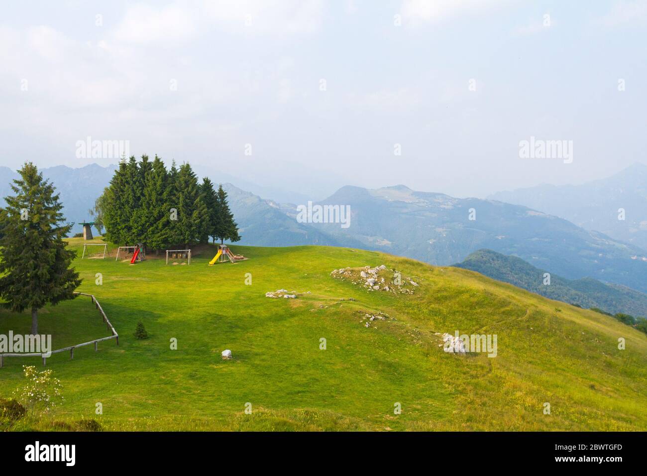 Colorful playground on a green mountain top Stock Photo - Alamy