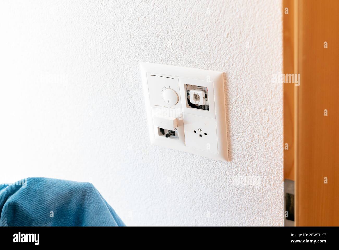 A close up of a professional cleaner cleaning a modern light switch and ...