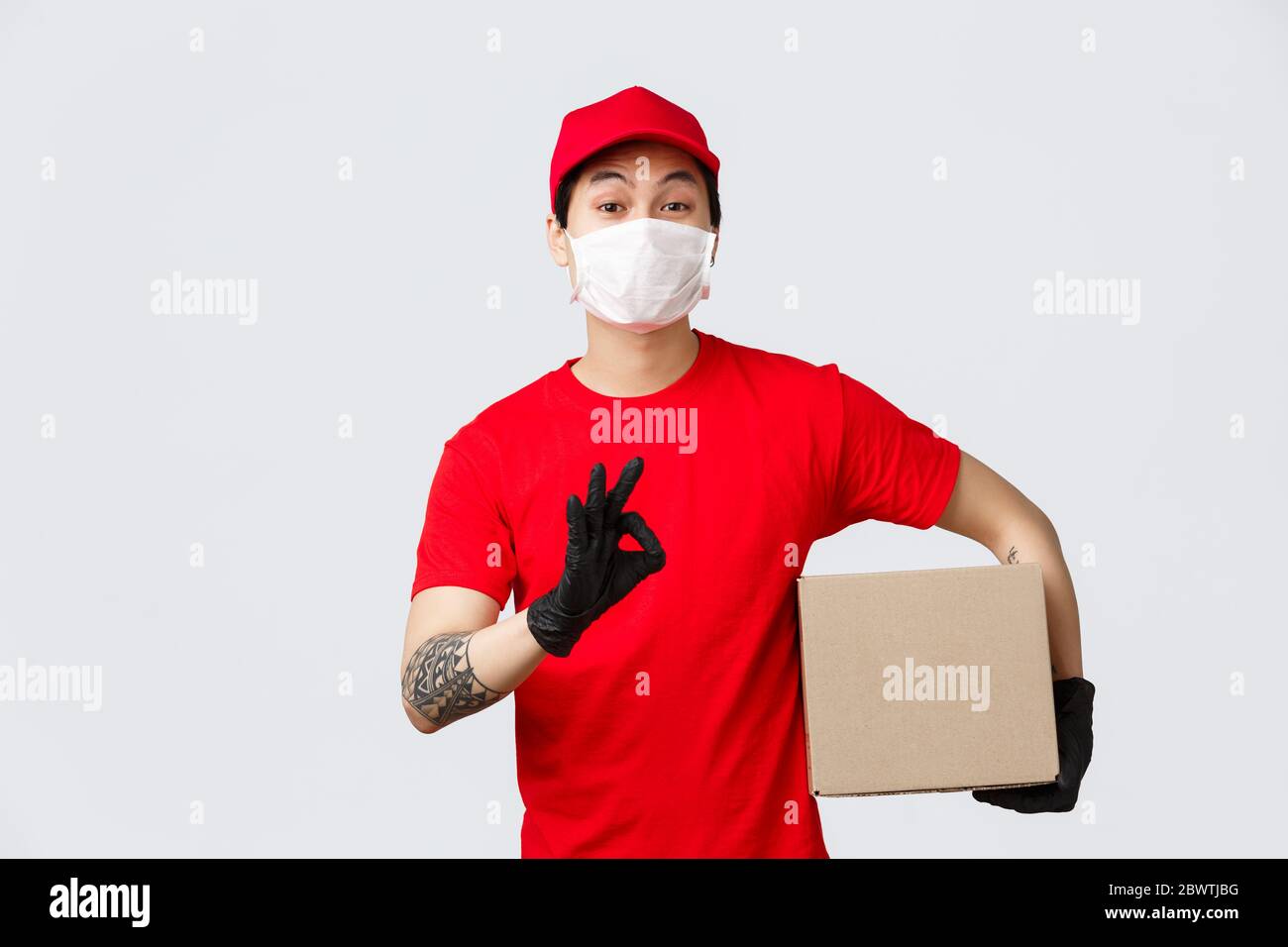 No problem we deliver your parcel. Asian delivery guy in uniform, red ...