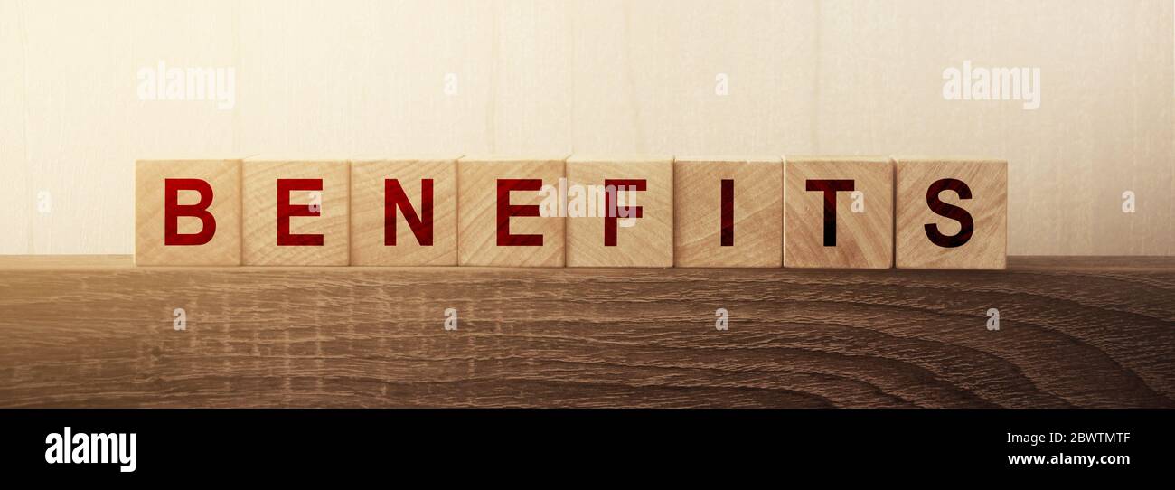 Benefits word written on wood block on wooden table. Business wellfare ...