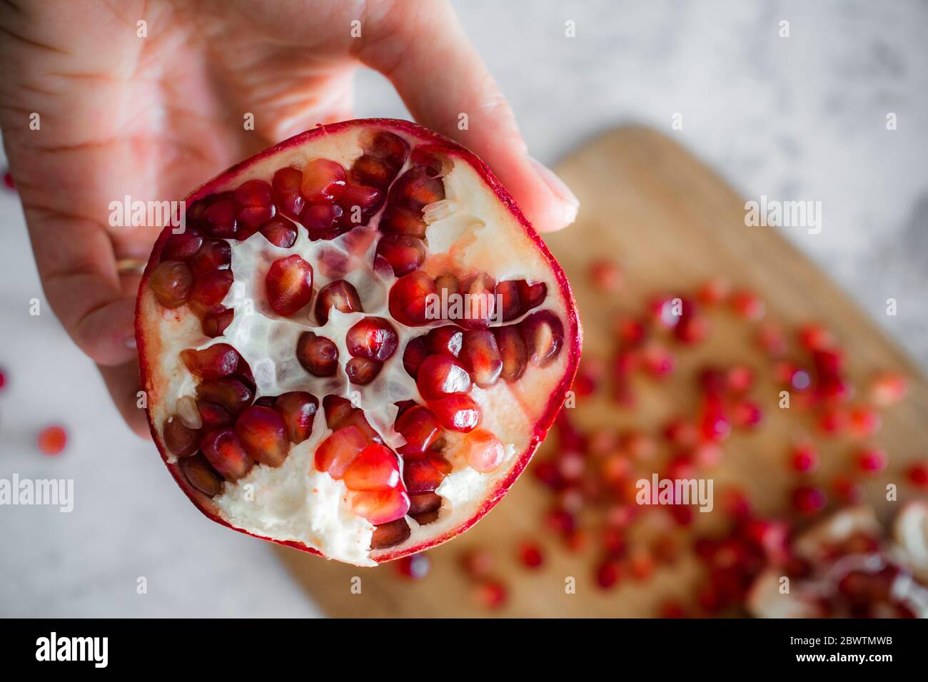 Hand Holding Pomegranate High Resolution Stock Photography and Images ...