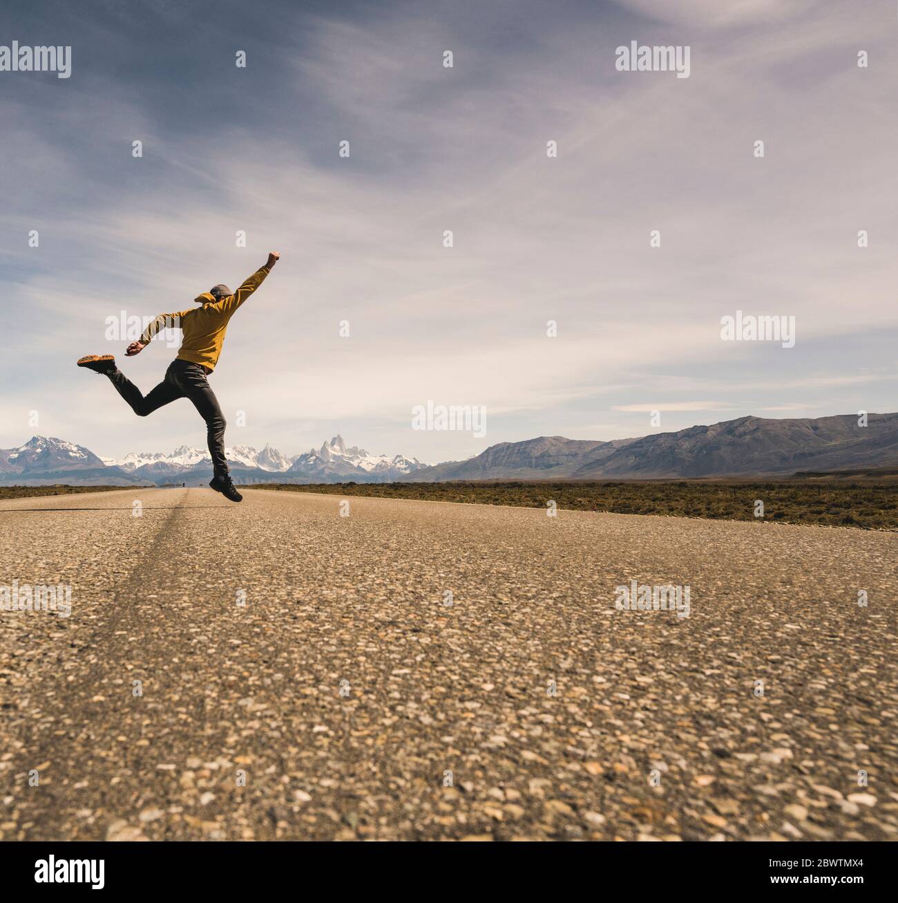 Man jumping on a road in remote landscape in Patagonia, Argentina Stock ...