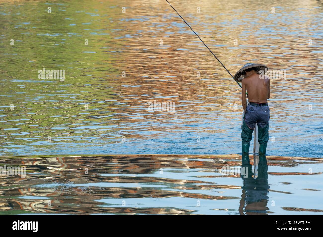 Feng Huang, China - August 2019 : Fisherman with a traditional ...