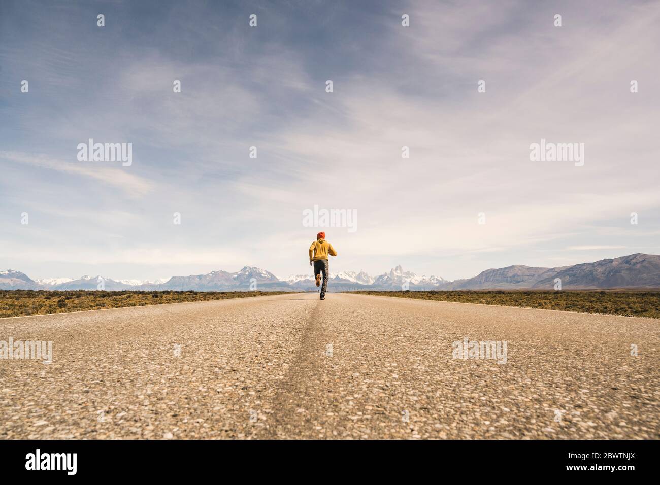 Man running on a road in remote landscape in Patagonia, Argentina Stock ...