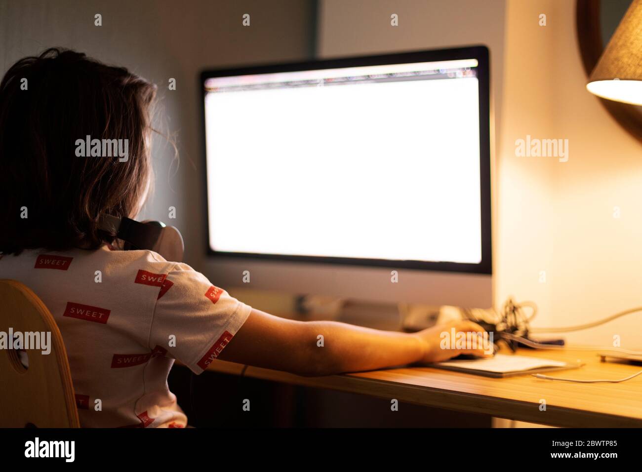 Rear view sitting at computer hi-res stock photography and images - Alamy