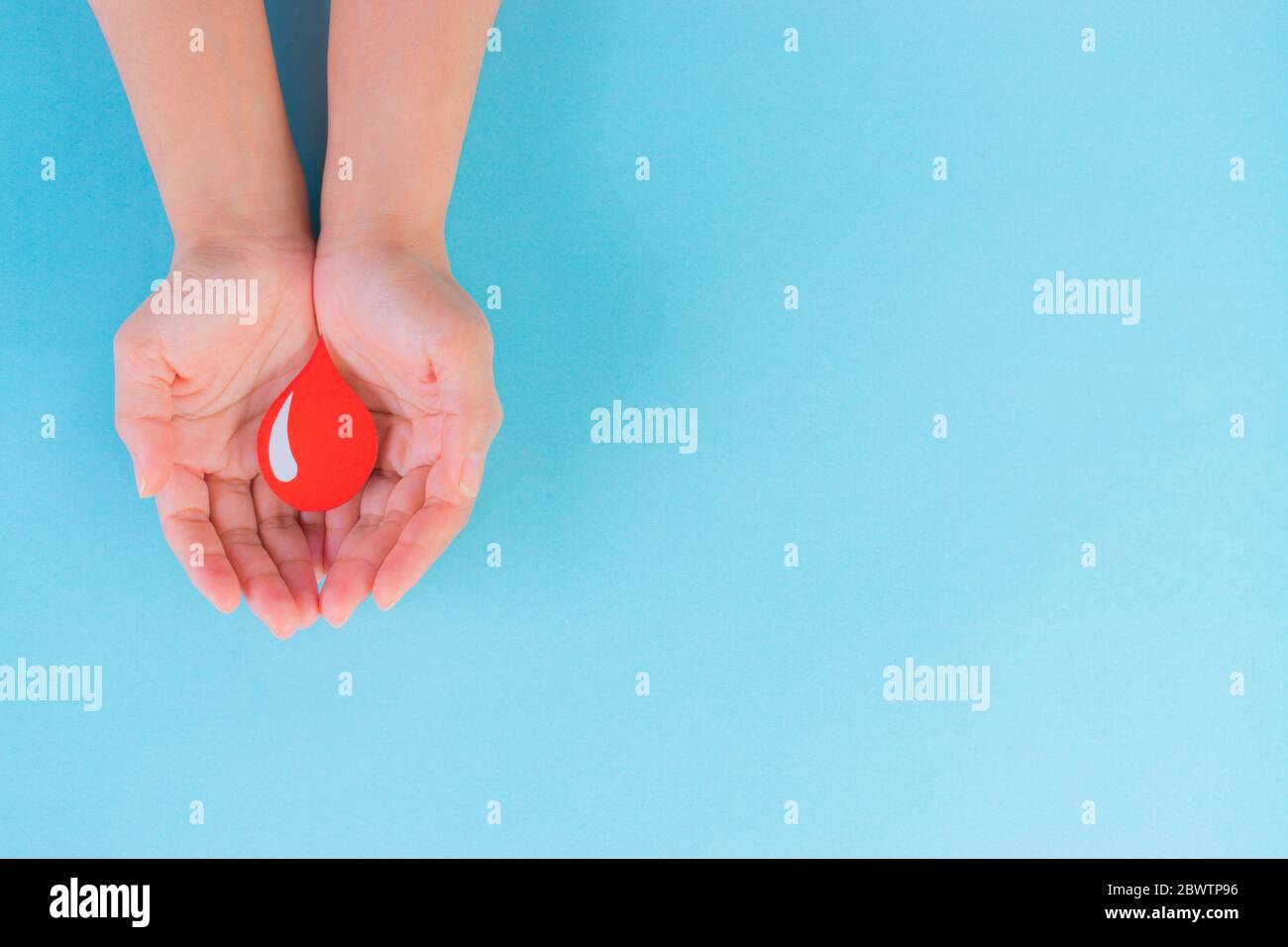 World Blood Donor and Hemophilia Day concept. Woman hands holding a red ...