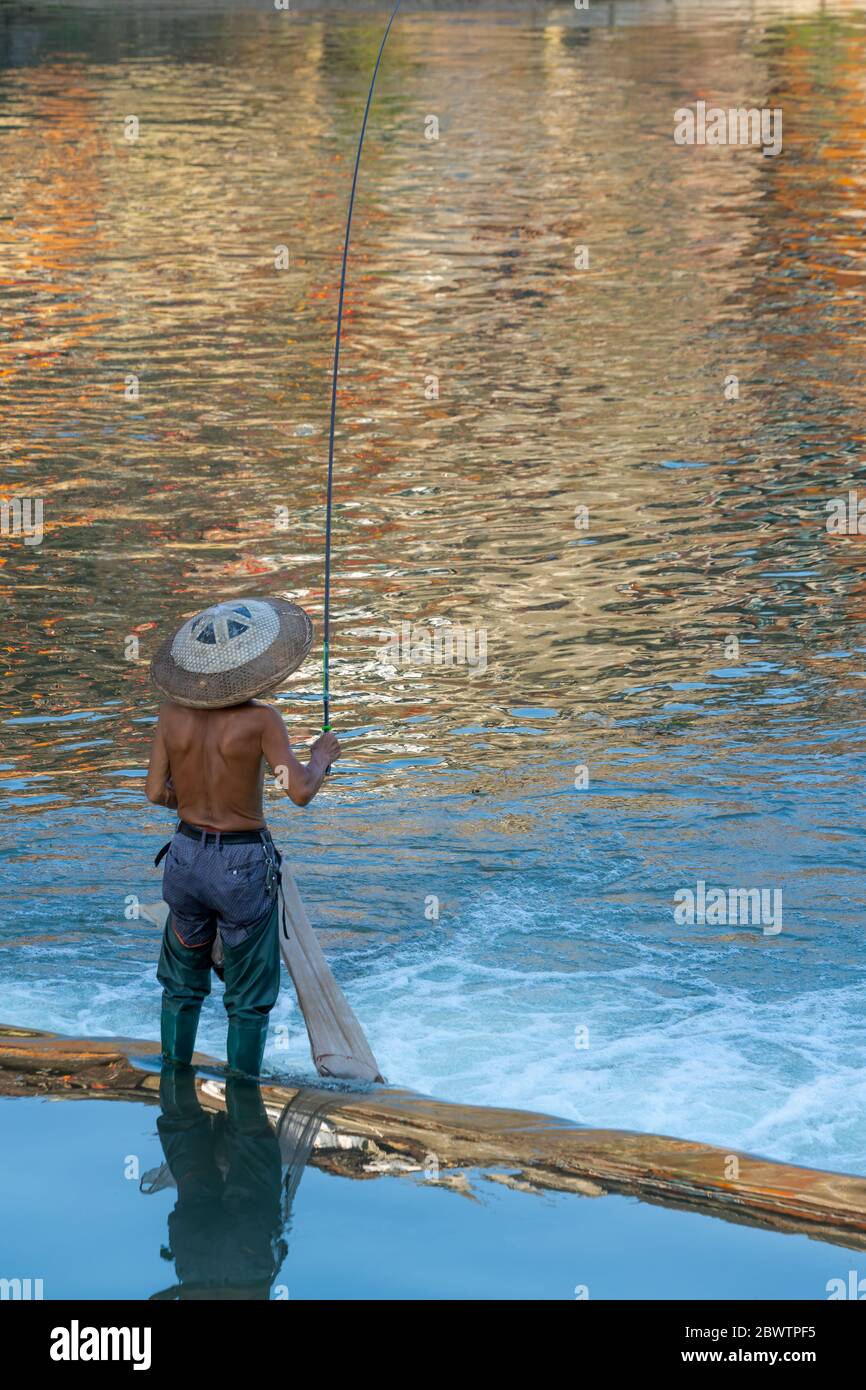 Feng Huang, China - August 2019 : Fisherman with a traditional ...
