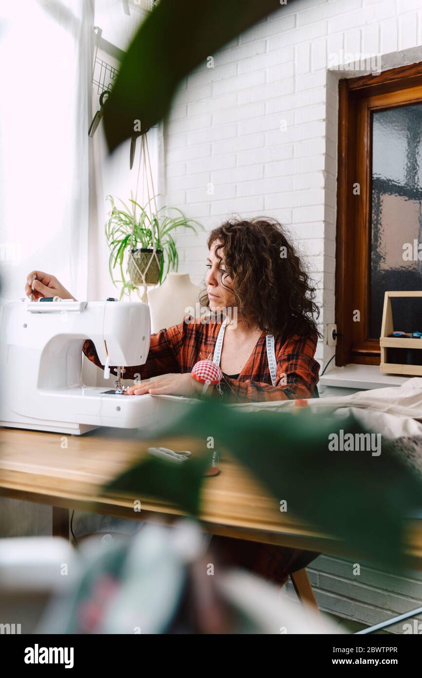 Woman sewing at home Stock Photo - Alamy