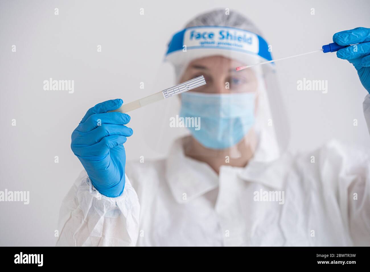 Putting in tube hi-res stock photography and images - Alamy