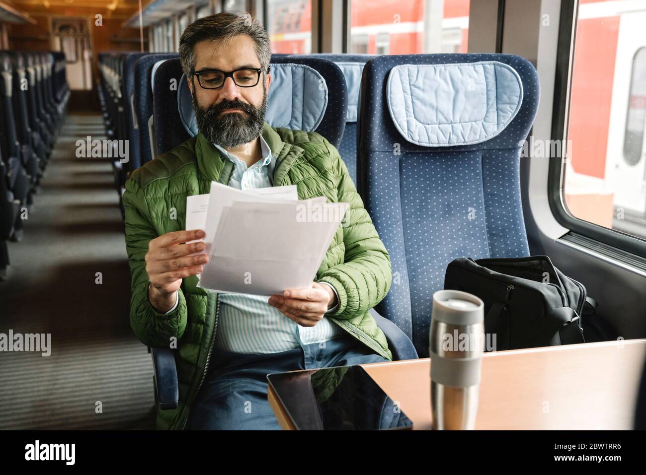 Business person reading paper on train hi-res stock photography and ...