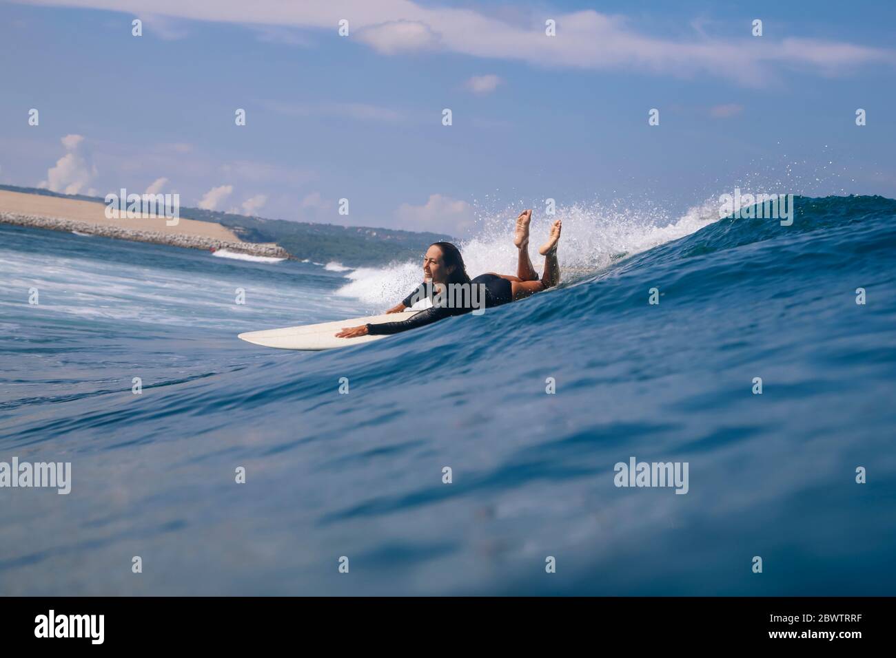 Woman surfing in the sea, Bali, Indonesia Stock Photo - Alamy