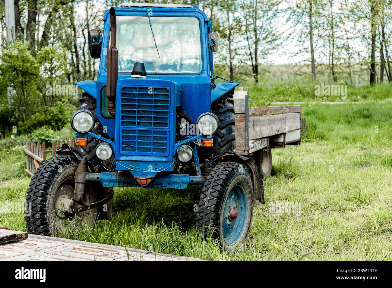 blue tractor stands on a street in Russia Stock Photo - Alamy