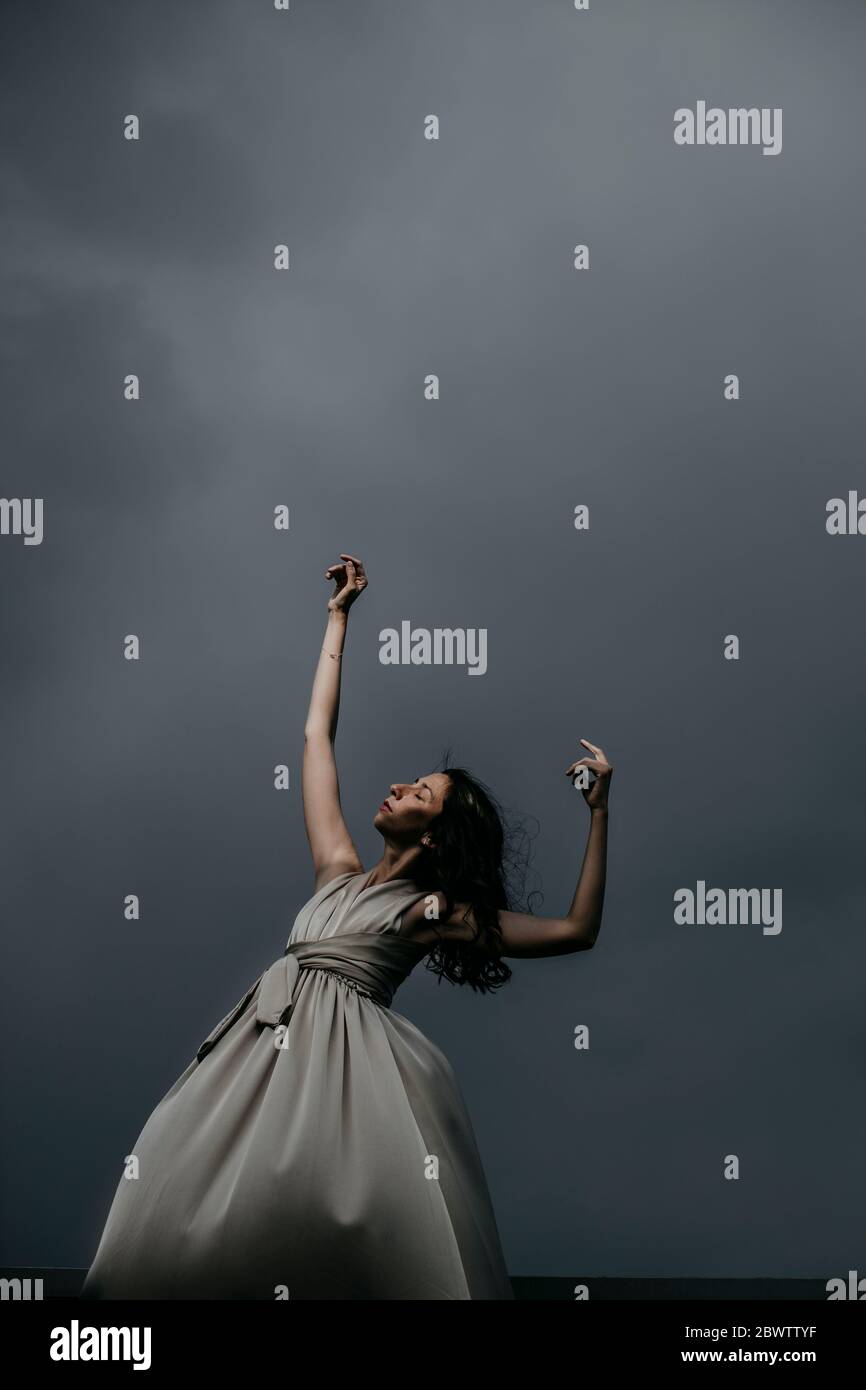 Woman arms raised dramatic hi-res stock photography and images - Alamy