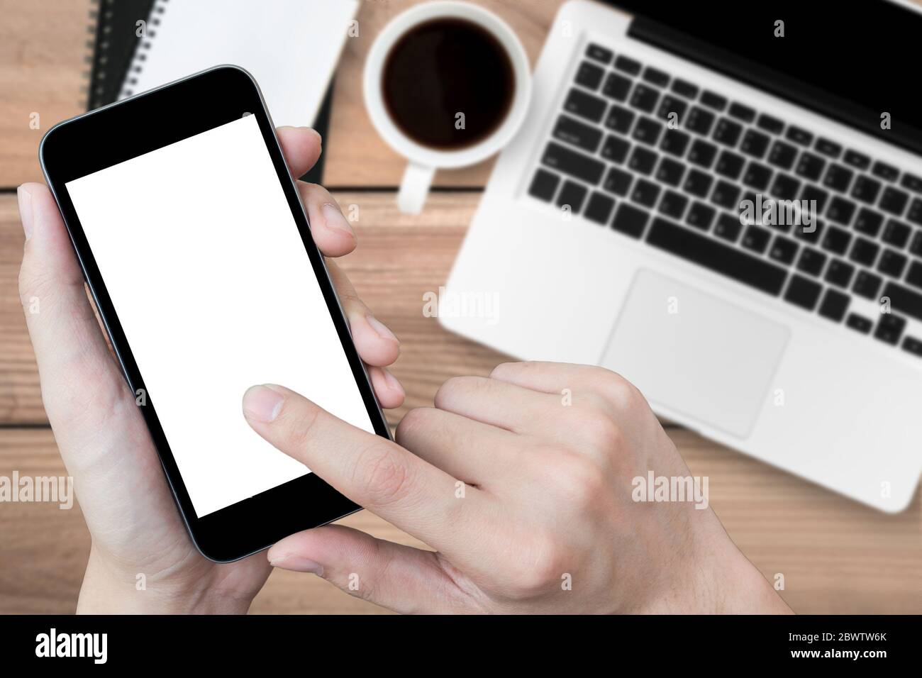 Man using smartphone over the office desk, top view Stock Photo - Alamy