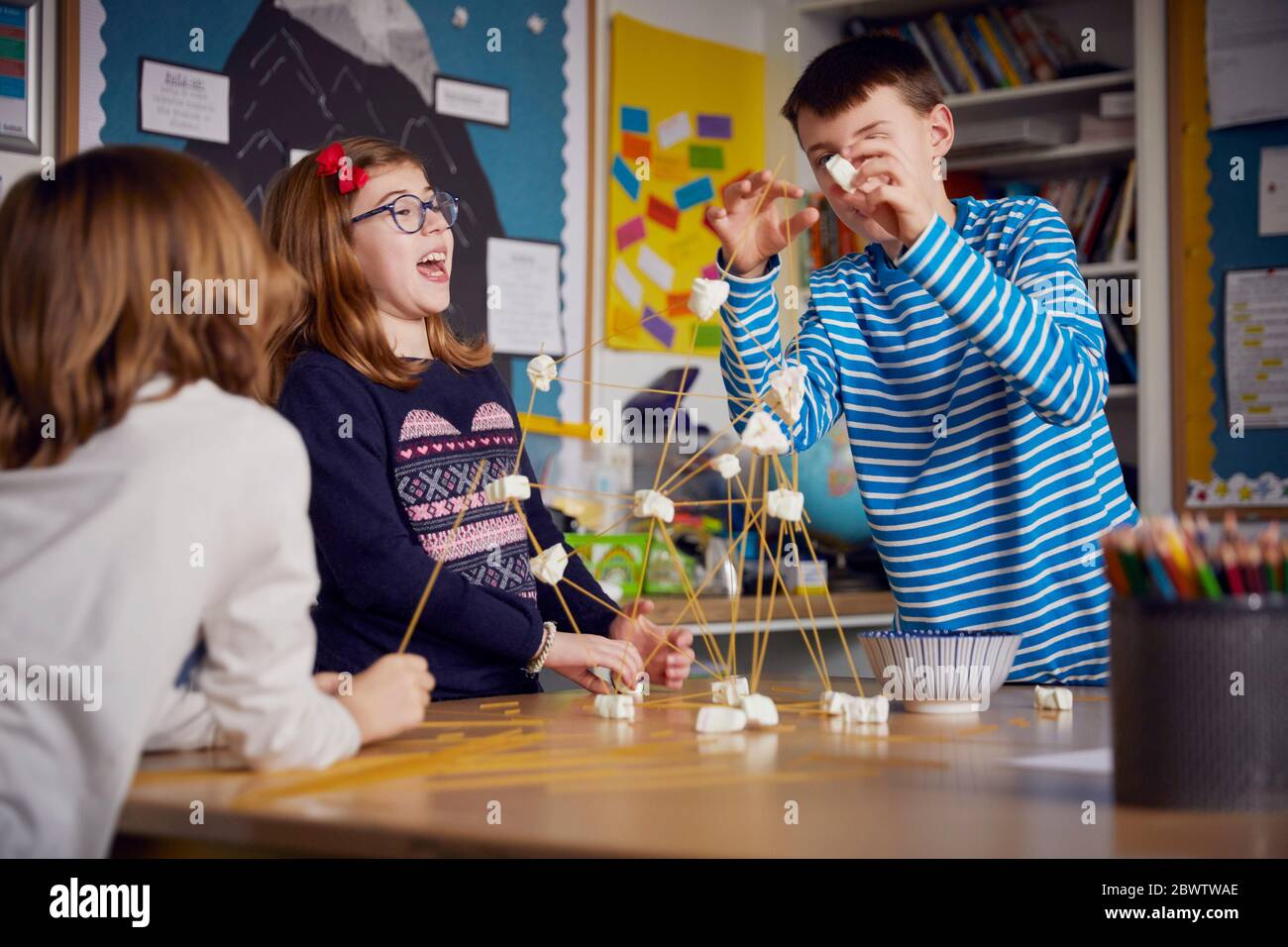 Three children during a science lesson Stock Photo - Alamy