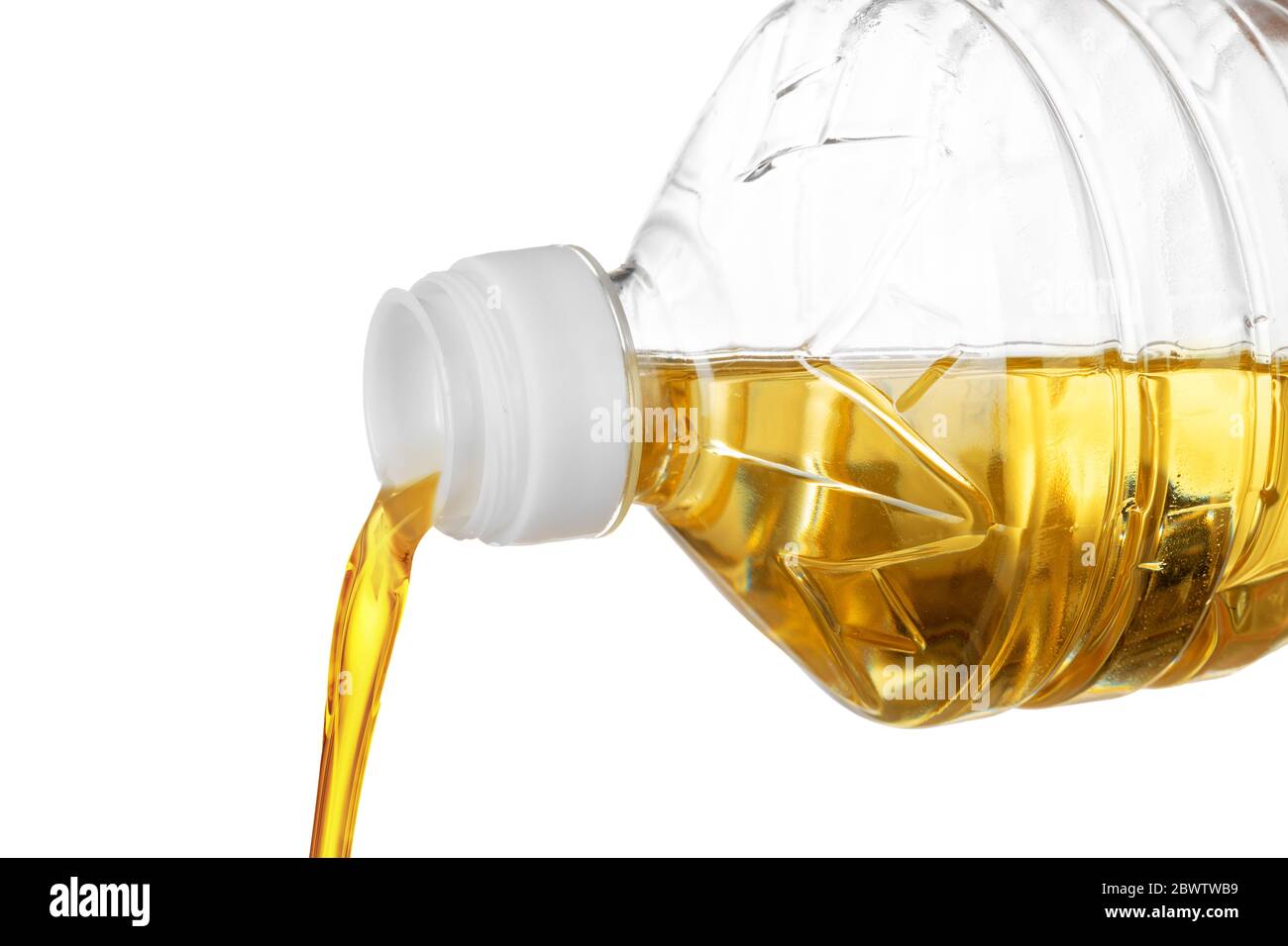 Pouring oil for cooking in a bottle isolated on white background Stock ...