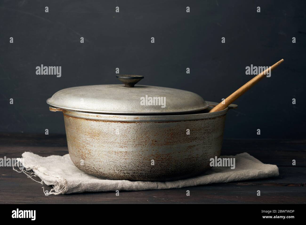 aluminum old cauldron on a wooden table, kitchen utensils, close up ...