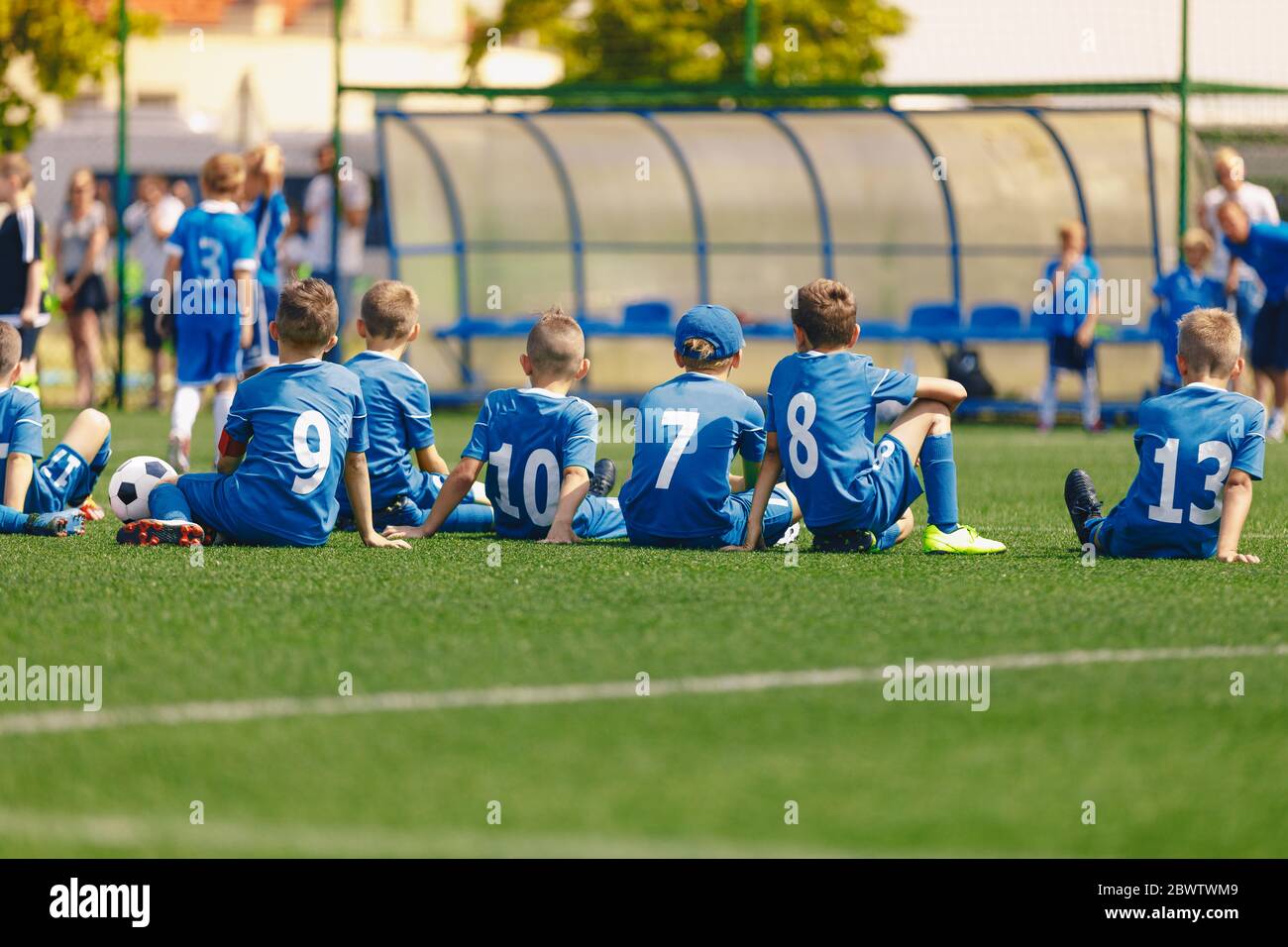 Youth Football Team Members Sitting Together on the Field. Kids Playing ...