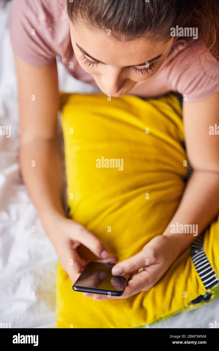 Woman smartphone lying on bed hi-res stock photography and images - Alamy
