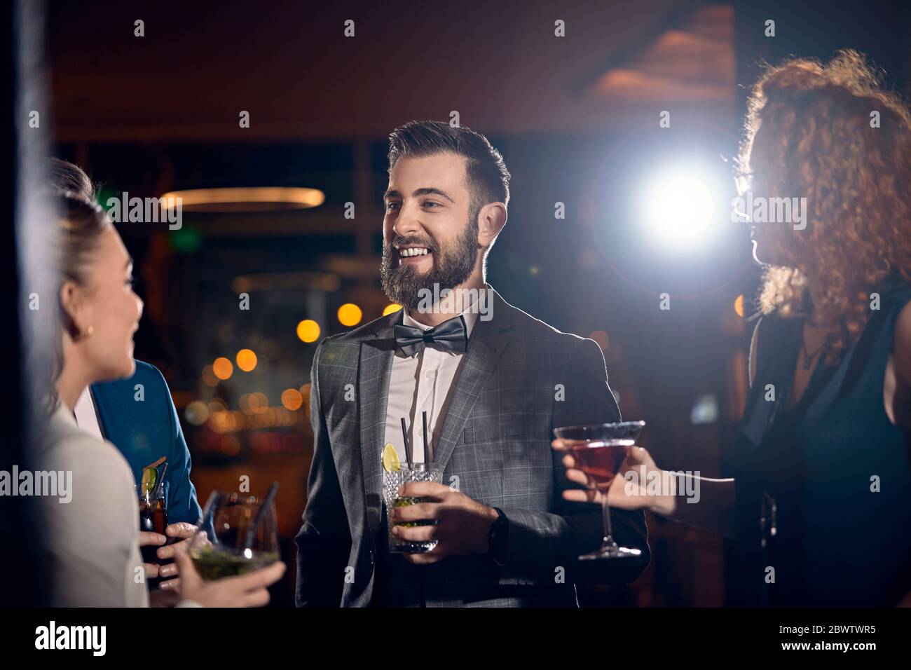 Happy friends socializing in a bar Stock Photo - Alamy