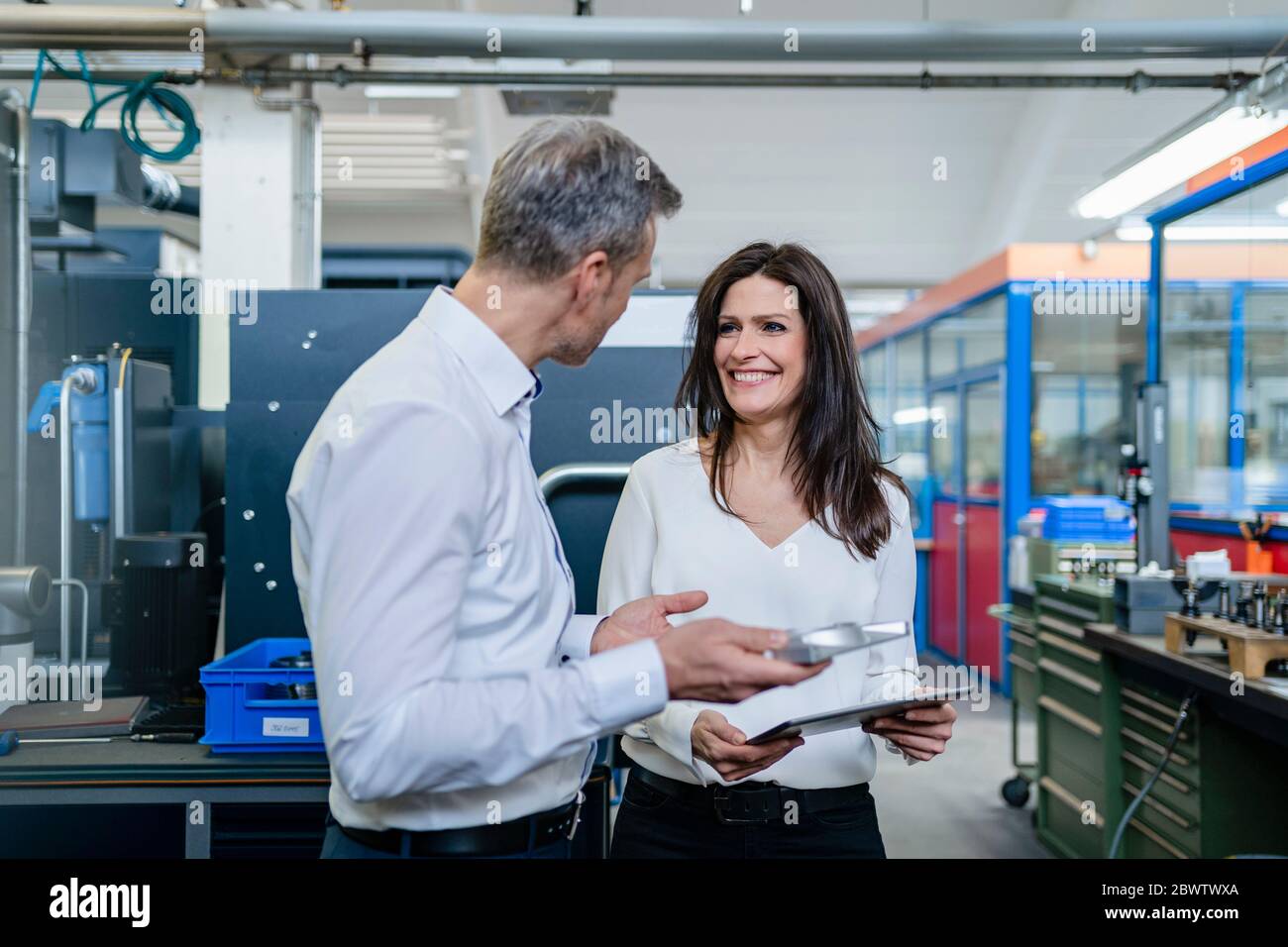 Businessman and businesswoman with product and tablet having a work ...