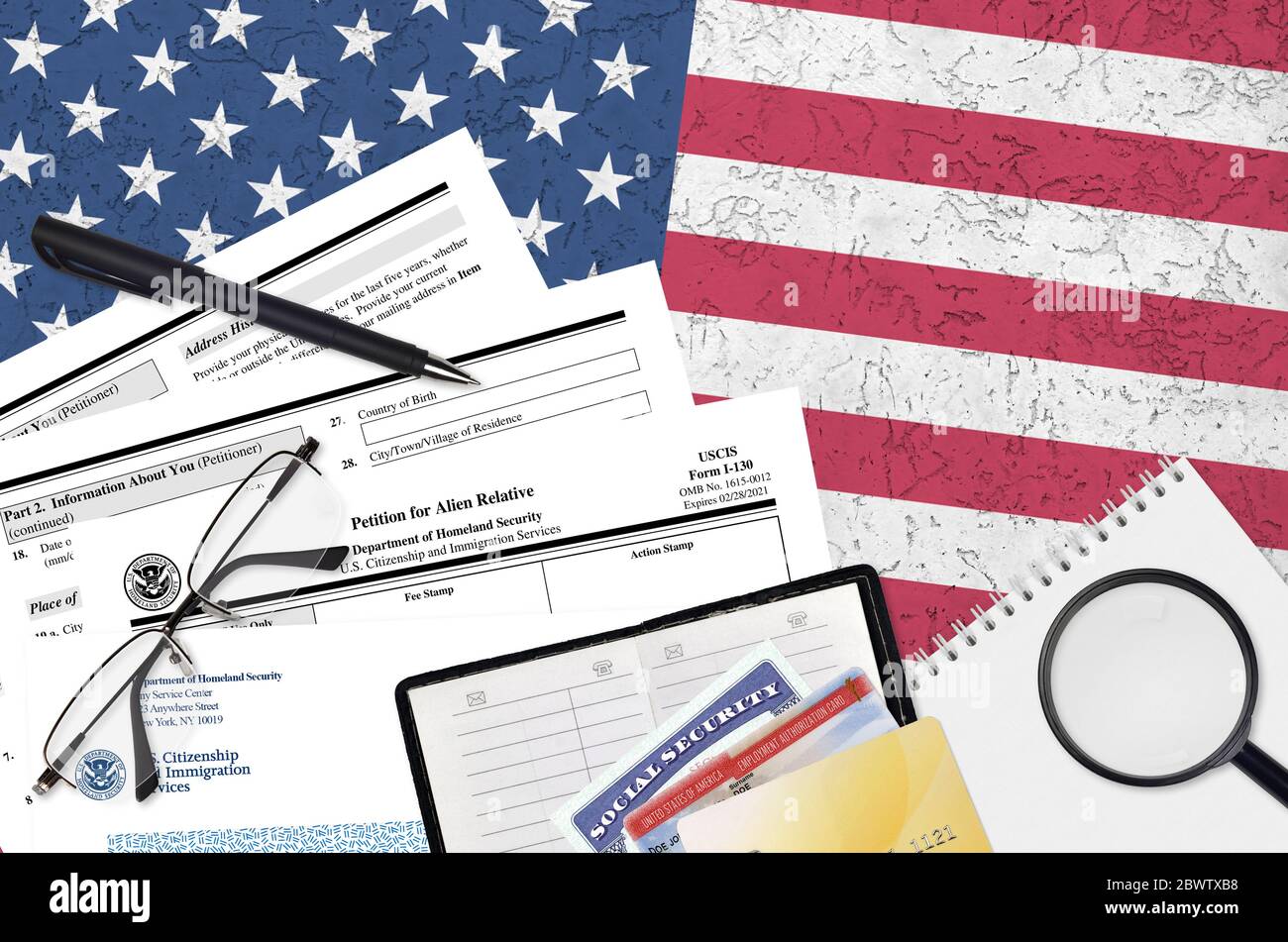 USCIS form I-130 petition for alien relative lies on flat lay office ...