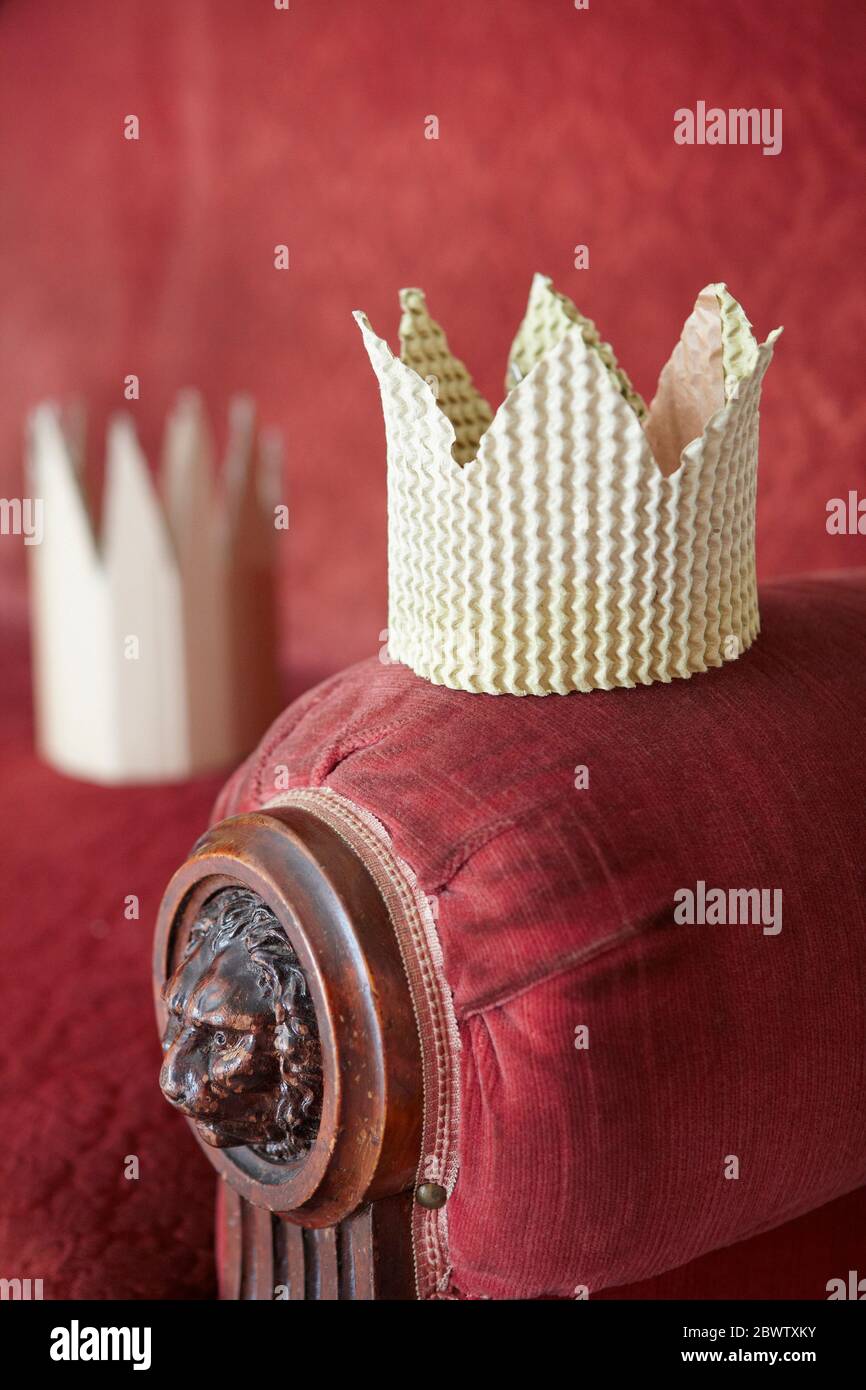 Cardboard crown on lounge chair Stock Photo - Alamy