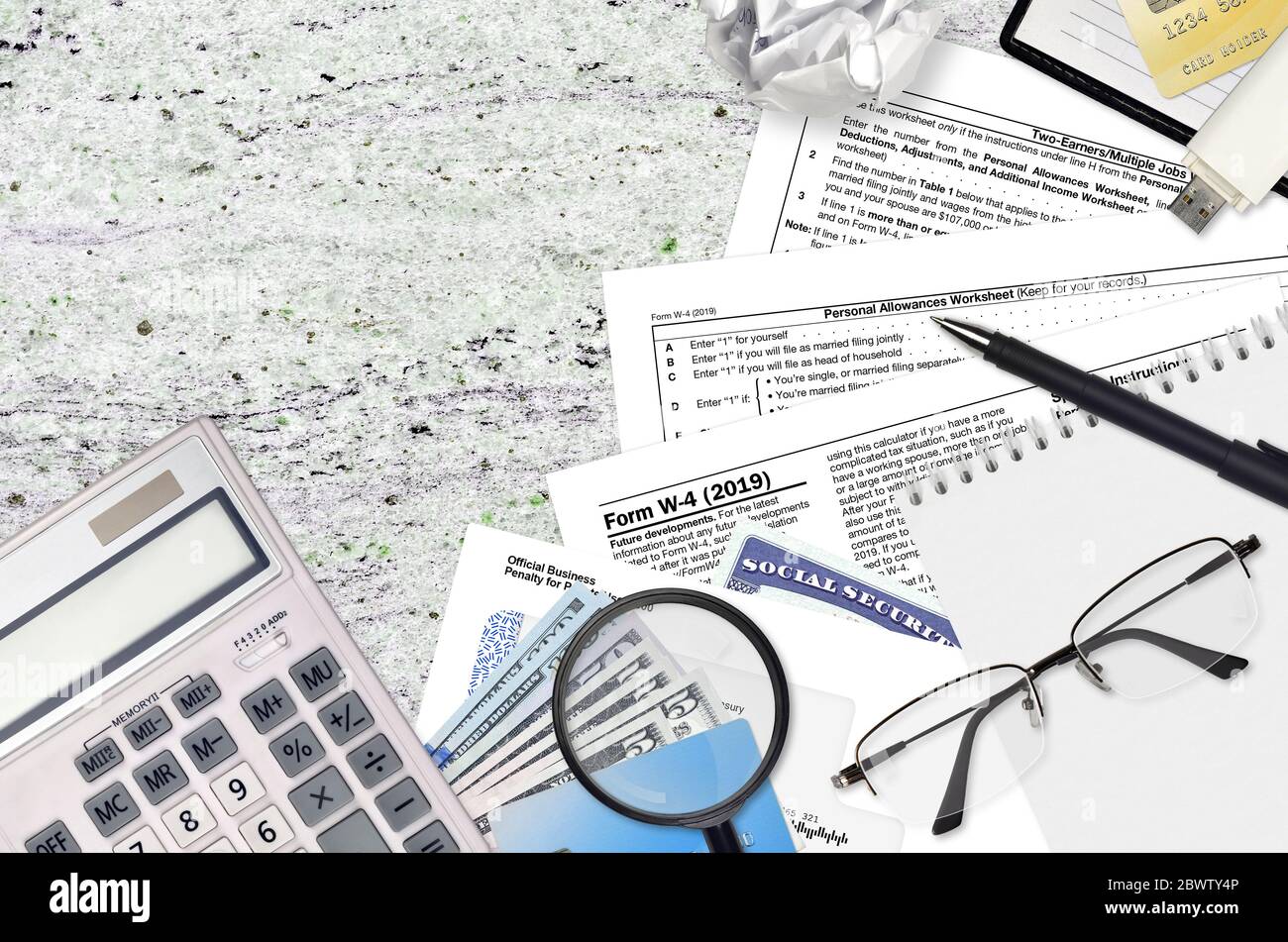 IRS form w-4 Employees Withholding Certificate lies on flat lay office ...