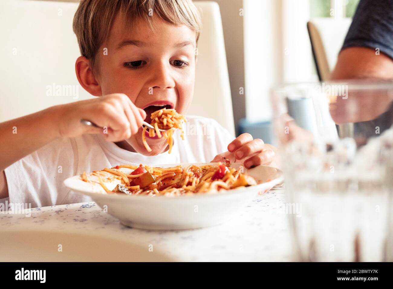 Portrait of boy eating Spaghetti Stock Photo - Alamy