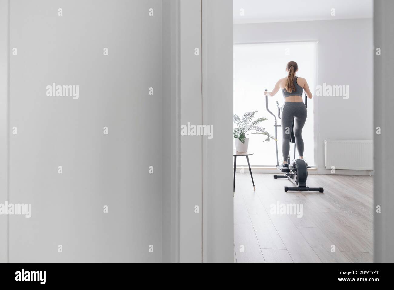 Woman exercises on elliptical hi-res stock photography and images - Alamy